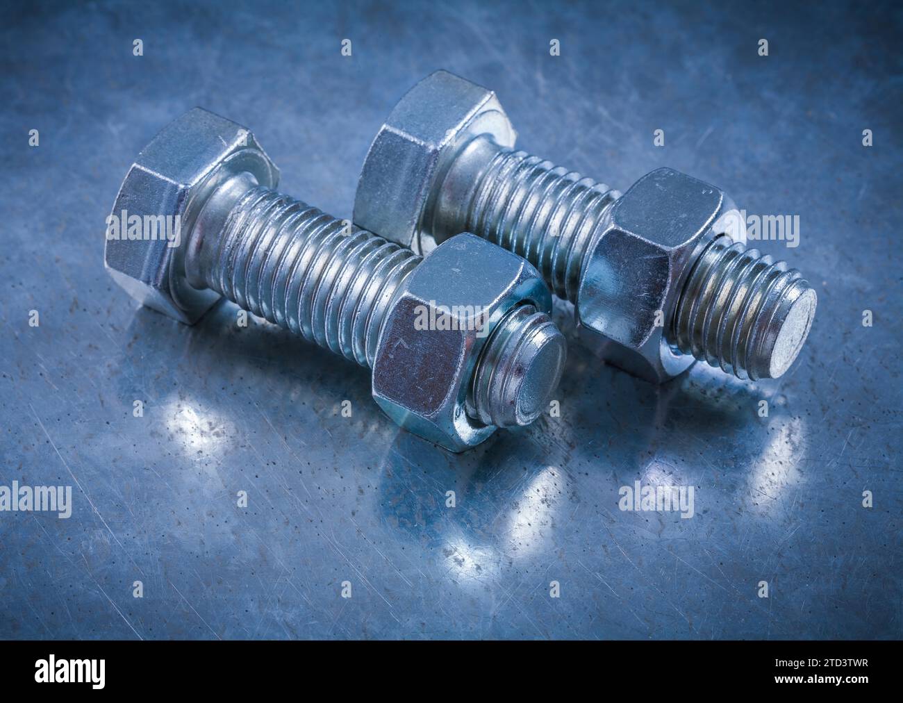 Compilation of threaded bolts and construction nuts on a metallic ...