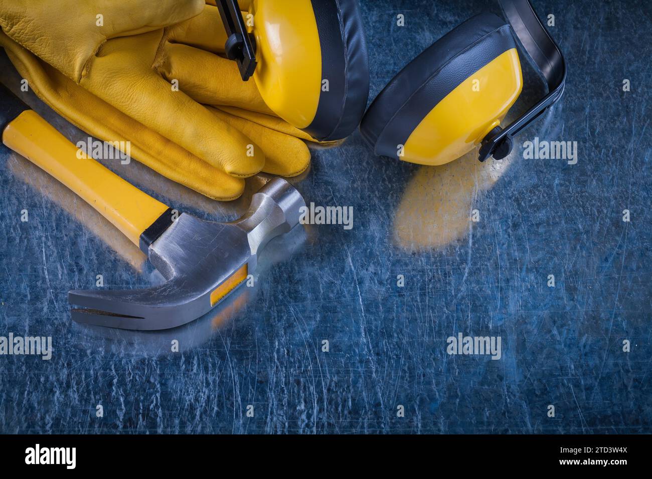 Soundproofing ear muffs Claw hammer and leather protective gloves on ...