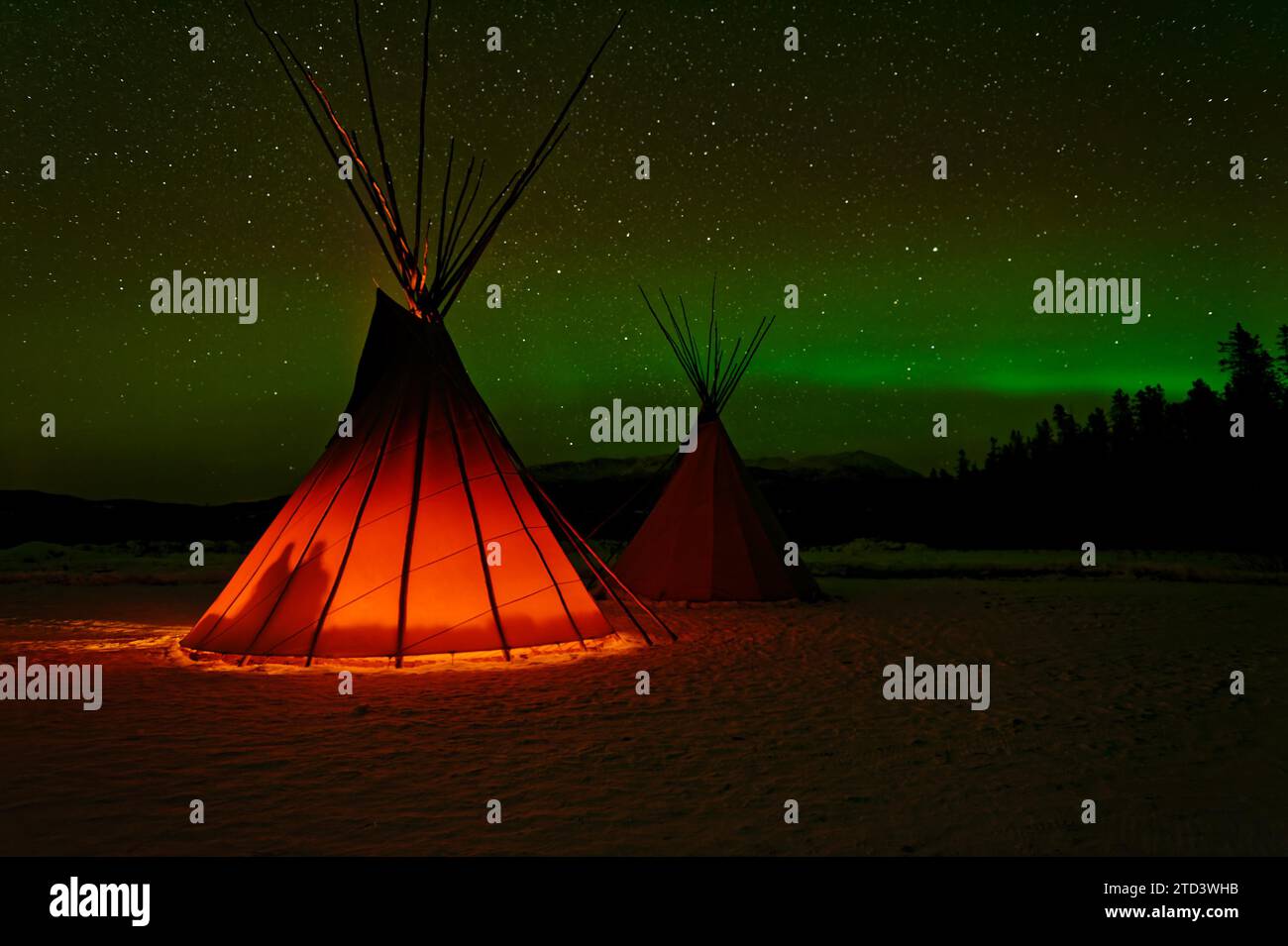 Two tents, tipis, Indian tents, front one illuminated from the inside ...