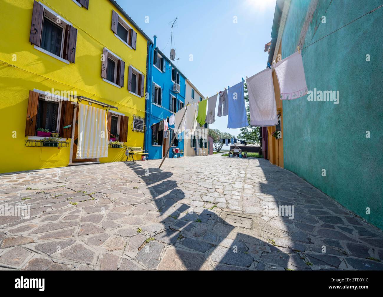 Clothesline between colourful houses, colourful house facades, alleys ...