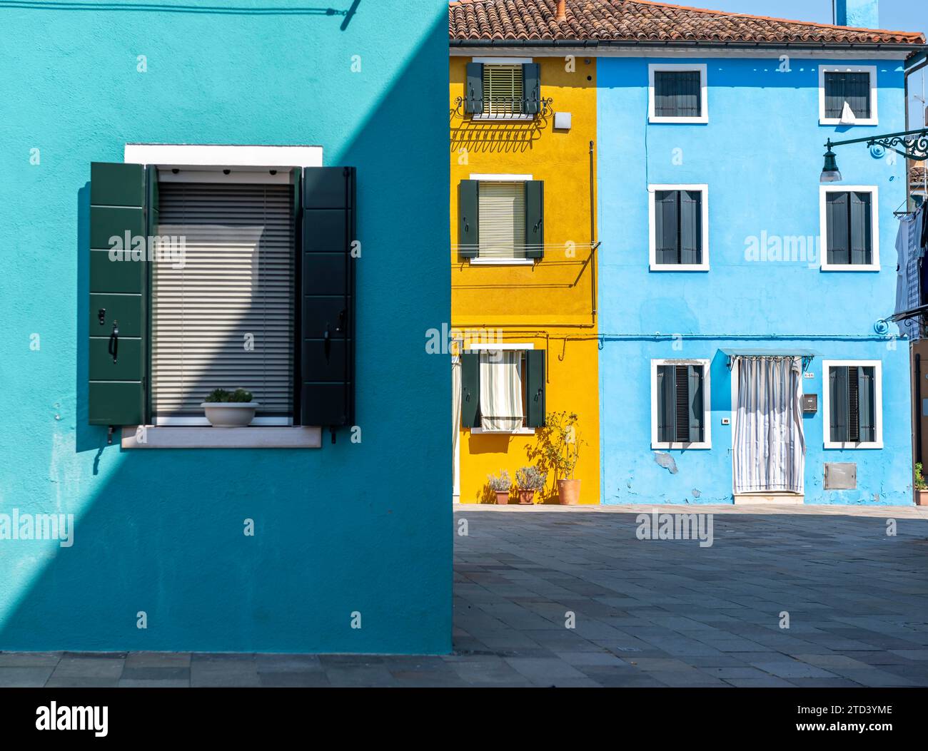 Blue and yellow house facades with entrance door and windows, colourful ...