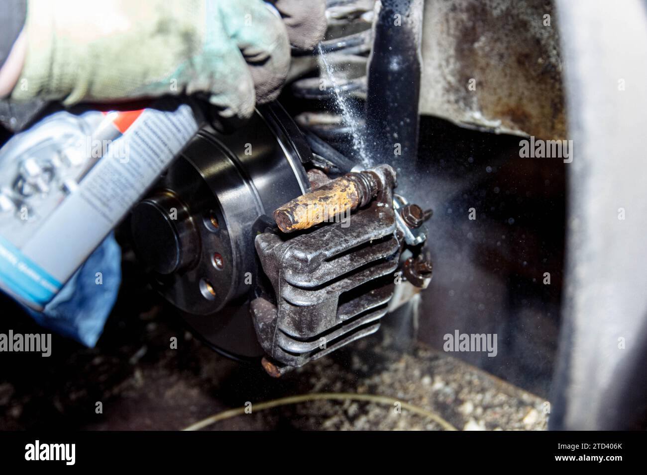 Cleaning car brake calipers and discs with a spray cleaner Stock Photo ...