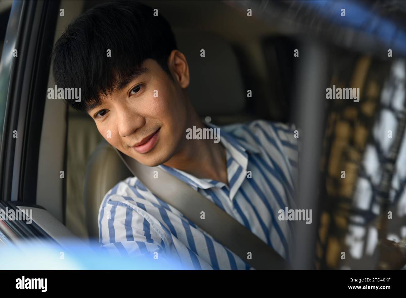 Happy cheerful young Asian man wearing casual outfit driving during ...