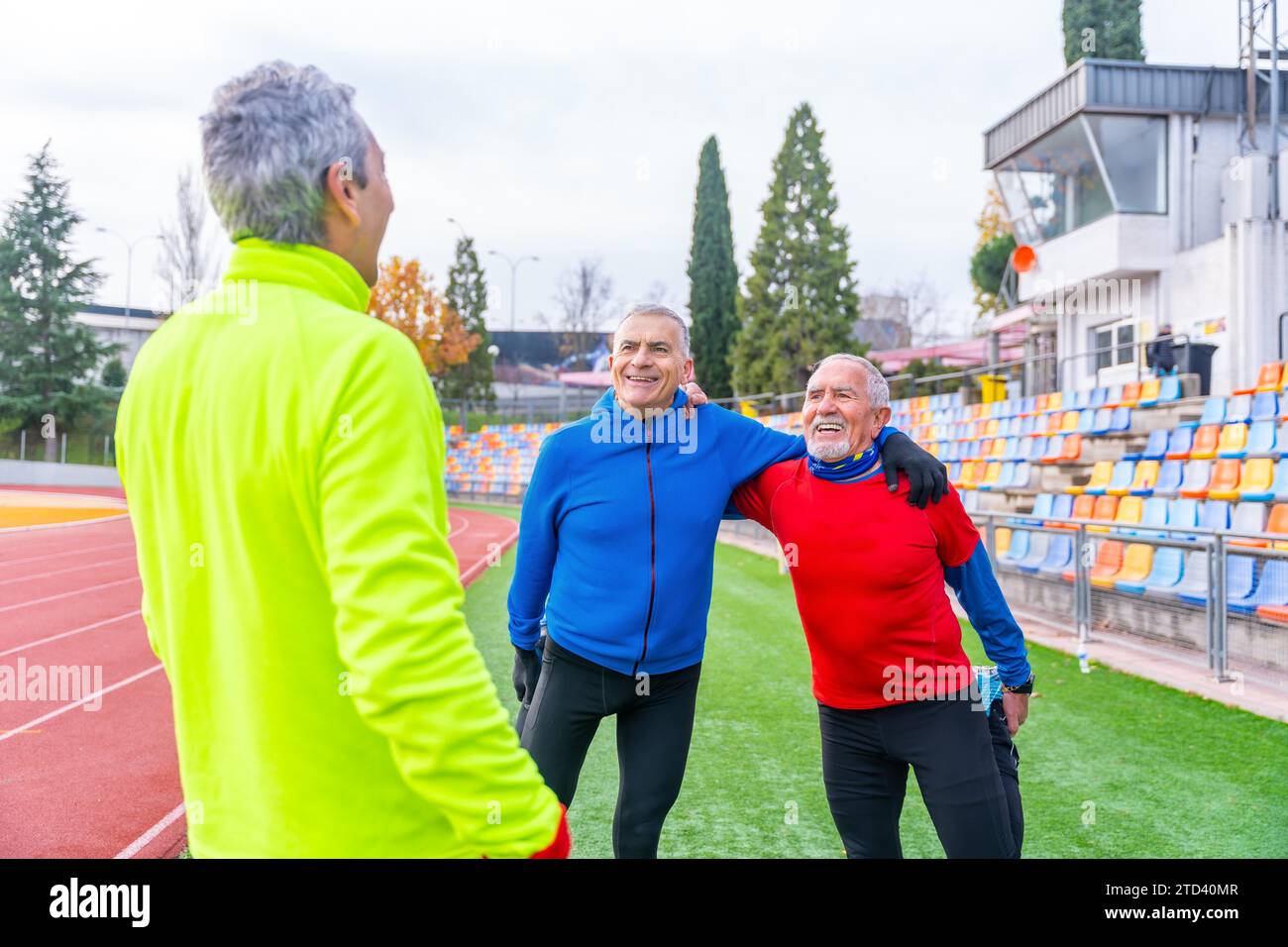 Retired elder three men warming up in an athletics field together Stock ...
