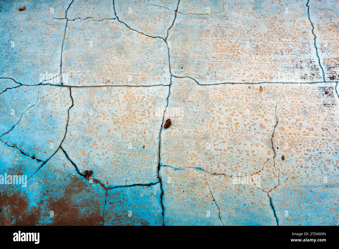 Dirty broken floor in a swimming pool, cracks, peeling paint ...