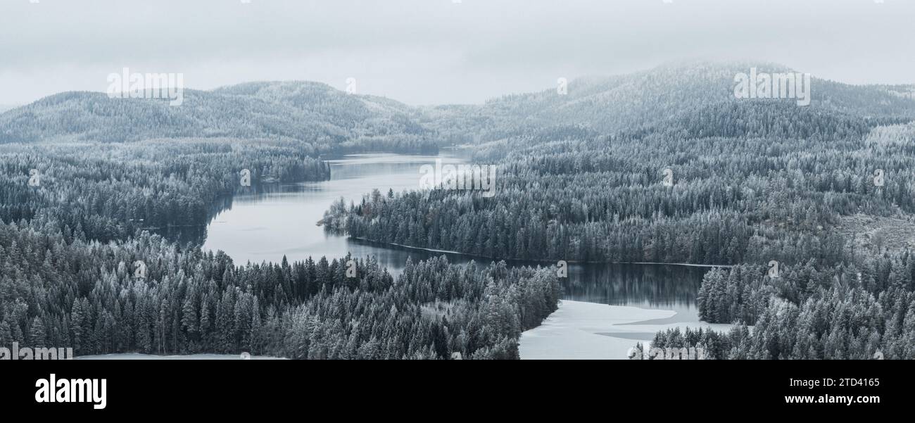 Taiga forest landscape with a lake and hills in winter Stock Photo - Alamy