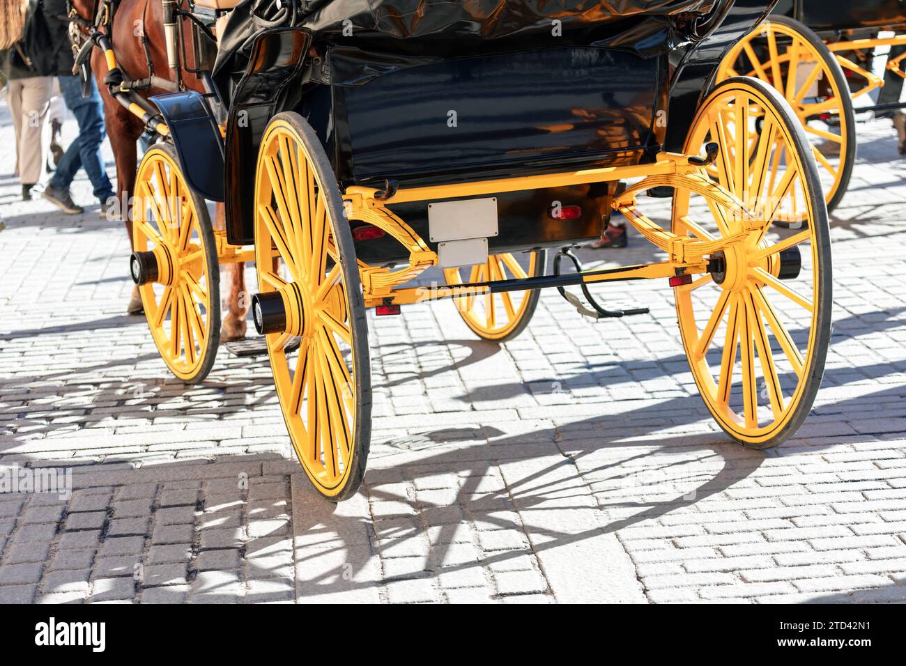 Horse carriage with yellow wheels on the city street . Charming horse ...