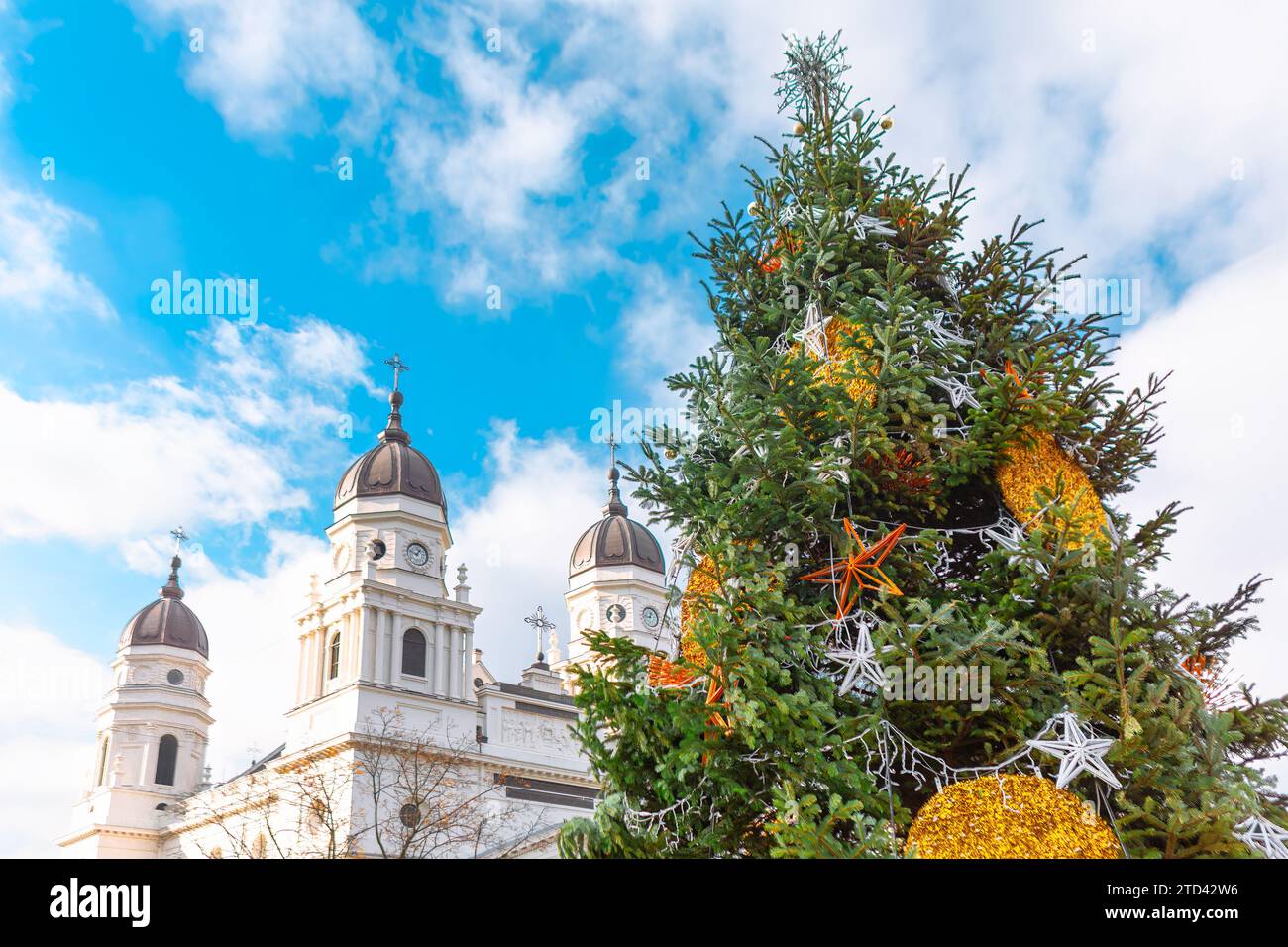 Beautiful Christmas tree in front of church on blue sky background ...