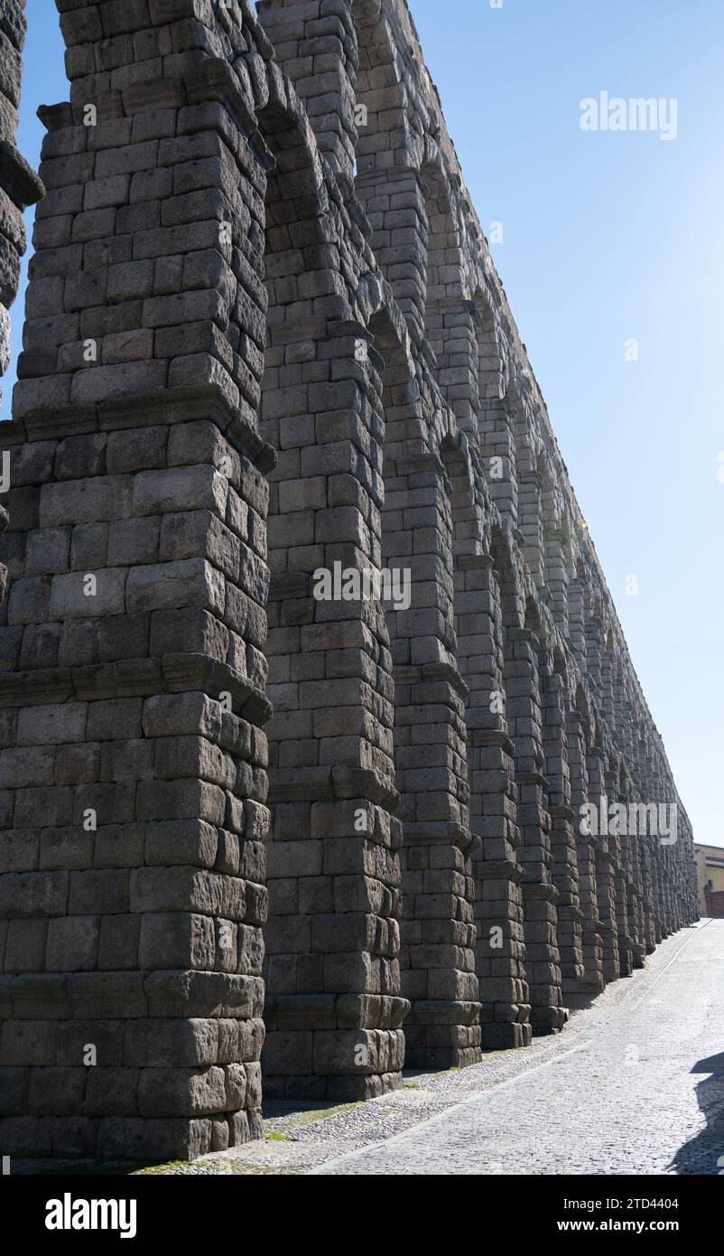 Ancient Roman aqueduct of Segovia with arches in perspective, clear ...