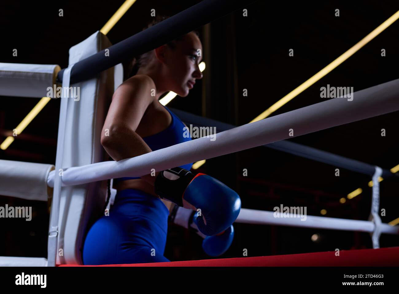 Powerful charged girl stands in the corner of the ring and is ready to ...
