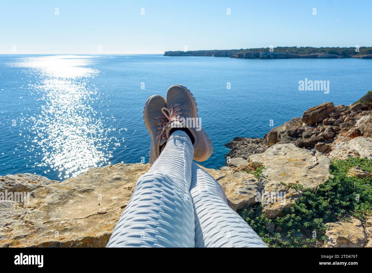 View trekking feet doing on cliff in front of the sea.panoramic ...