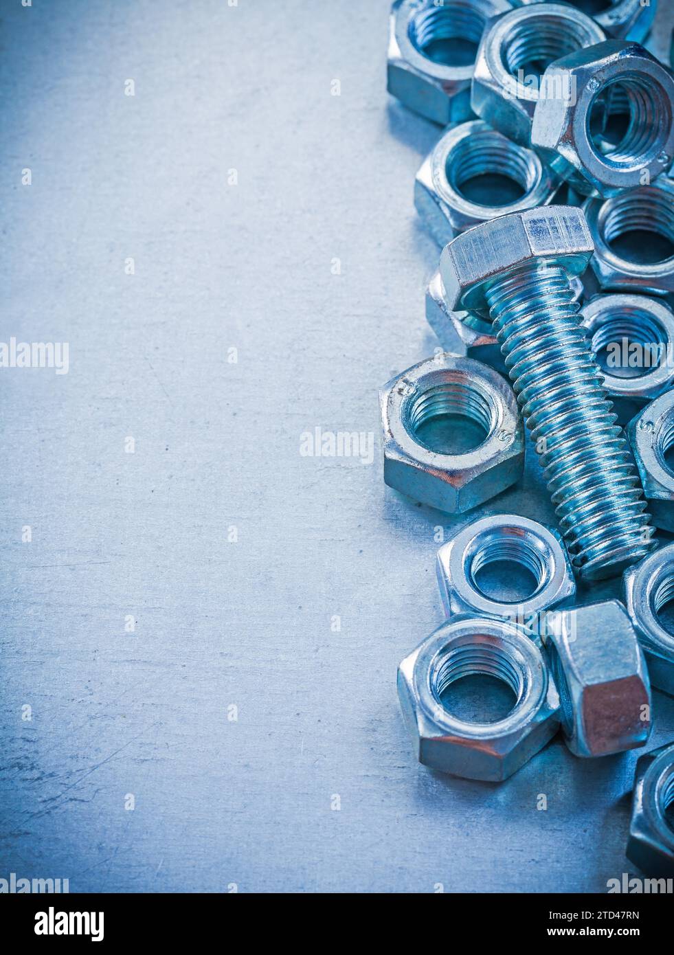 Threaded nuts and bolts on a metallic background Design concept Stock ...