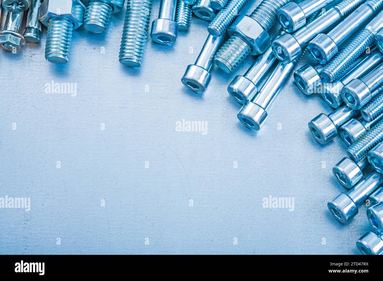 Heap of metal threaded hexagon bolts on metallic background repairing ...