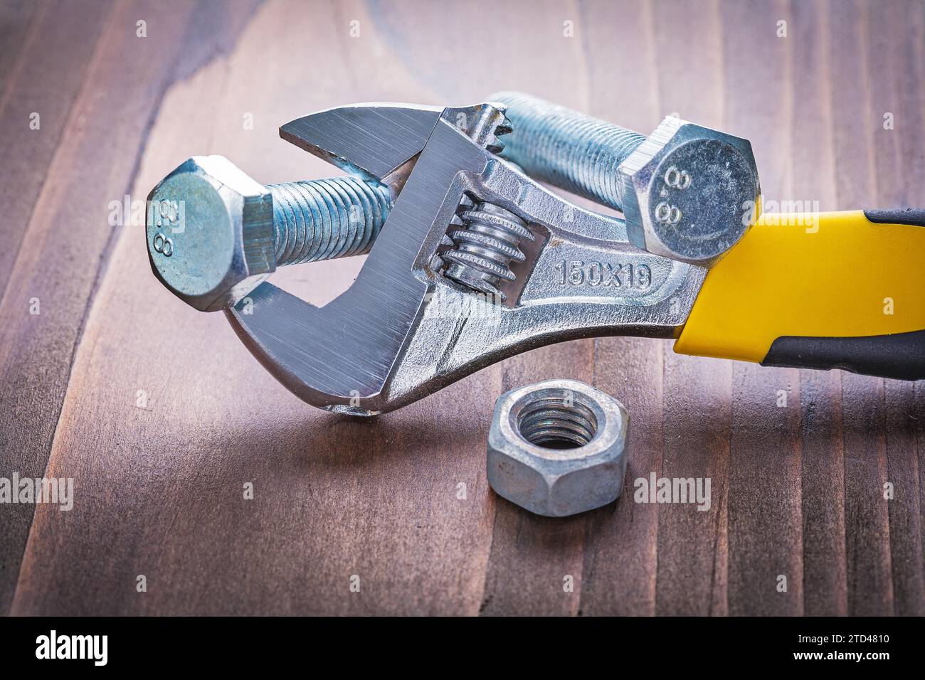 Adjustable spanner screws and nut on vintage wooden board Construction ...