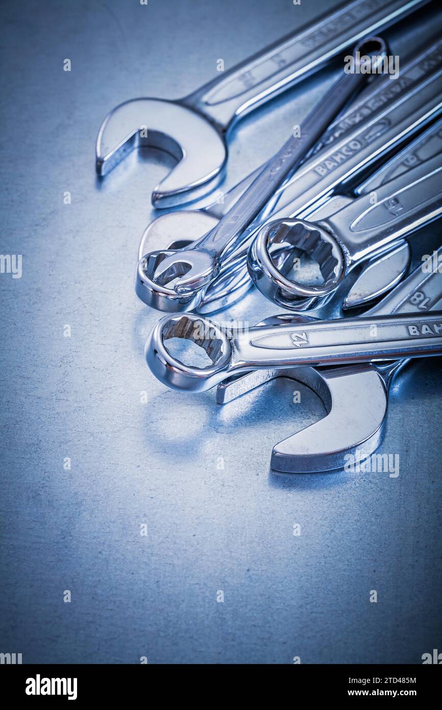 Flat spanner and open-end spanner on a metallic background Repair ...