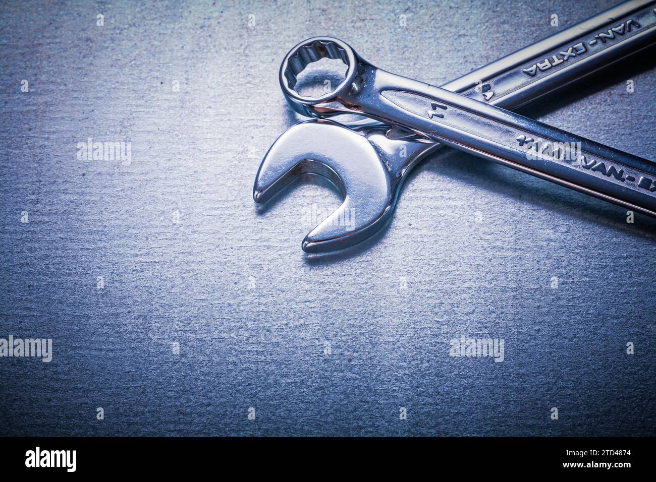 Flat spanner and hook spanner on a metallic background Design concept ...