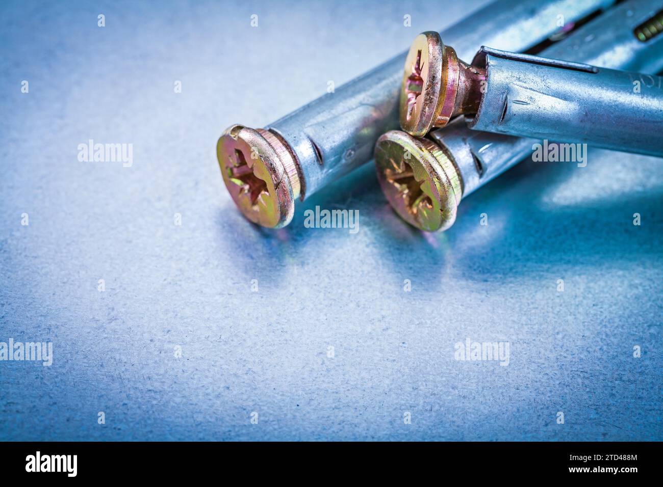 Metal anchor bolts for concrete walls on a metallic background ...