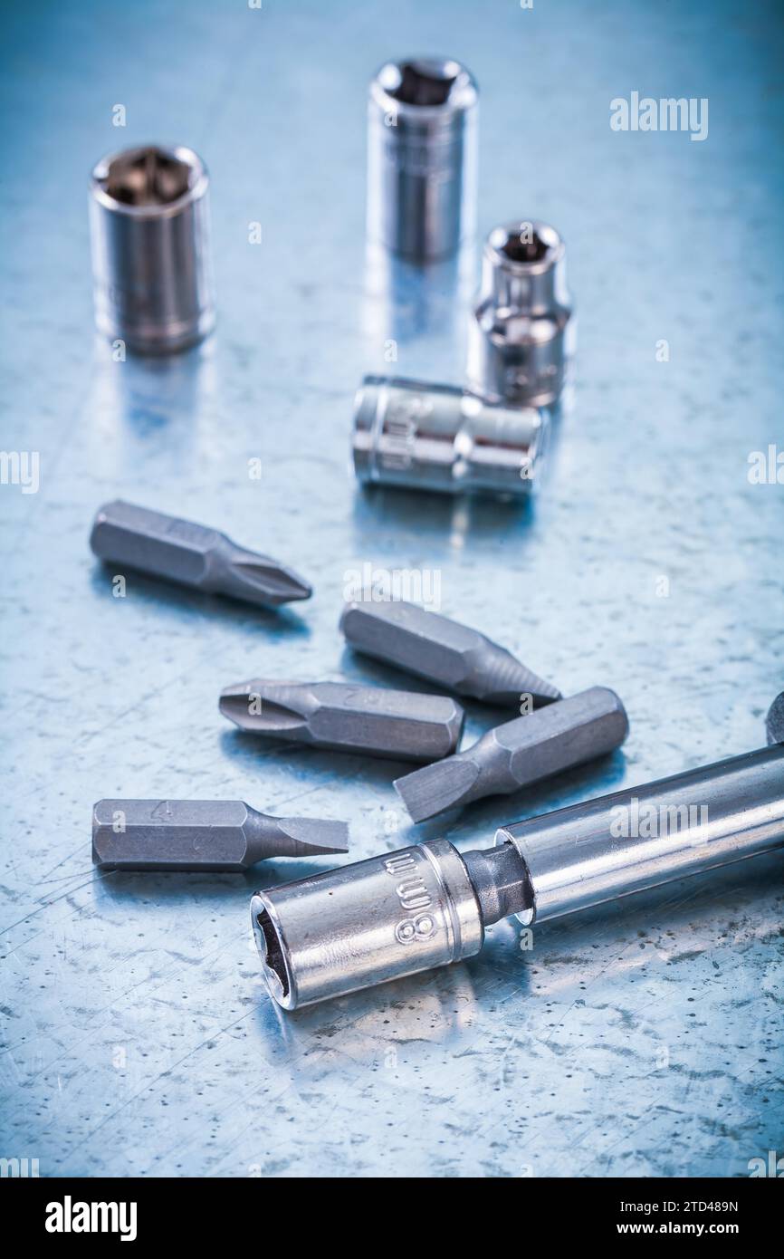 Metallic background with screwdriver and composition of steel screws ...
