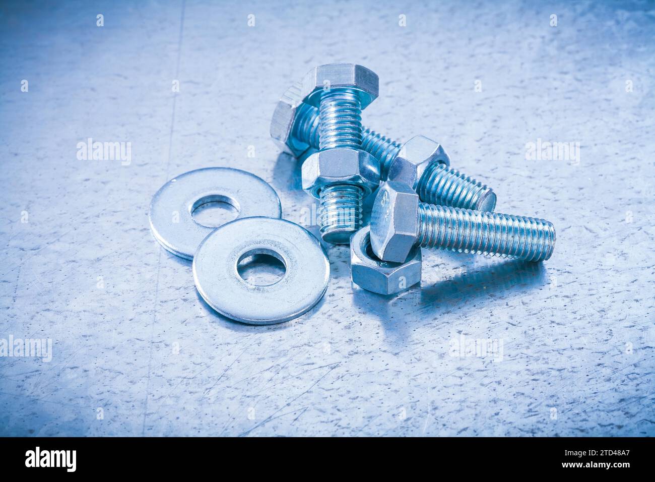 Metal threaded screws Nuts and bolts Washers on metallic background ...