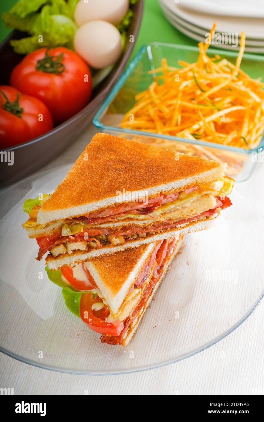 Fresh and delicious classic club sandwich over a transparent glass dish ...