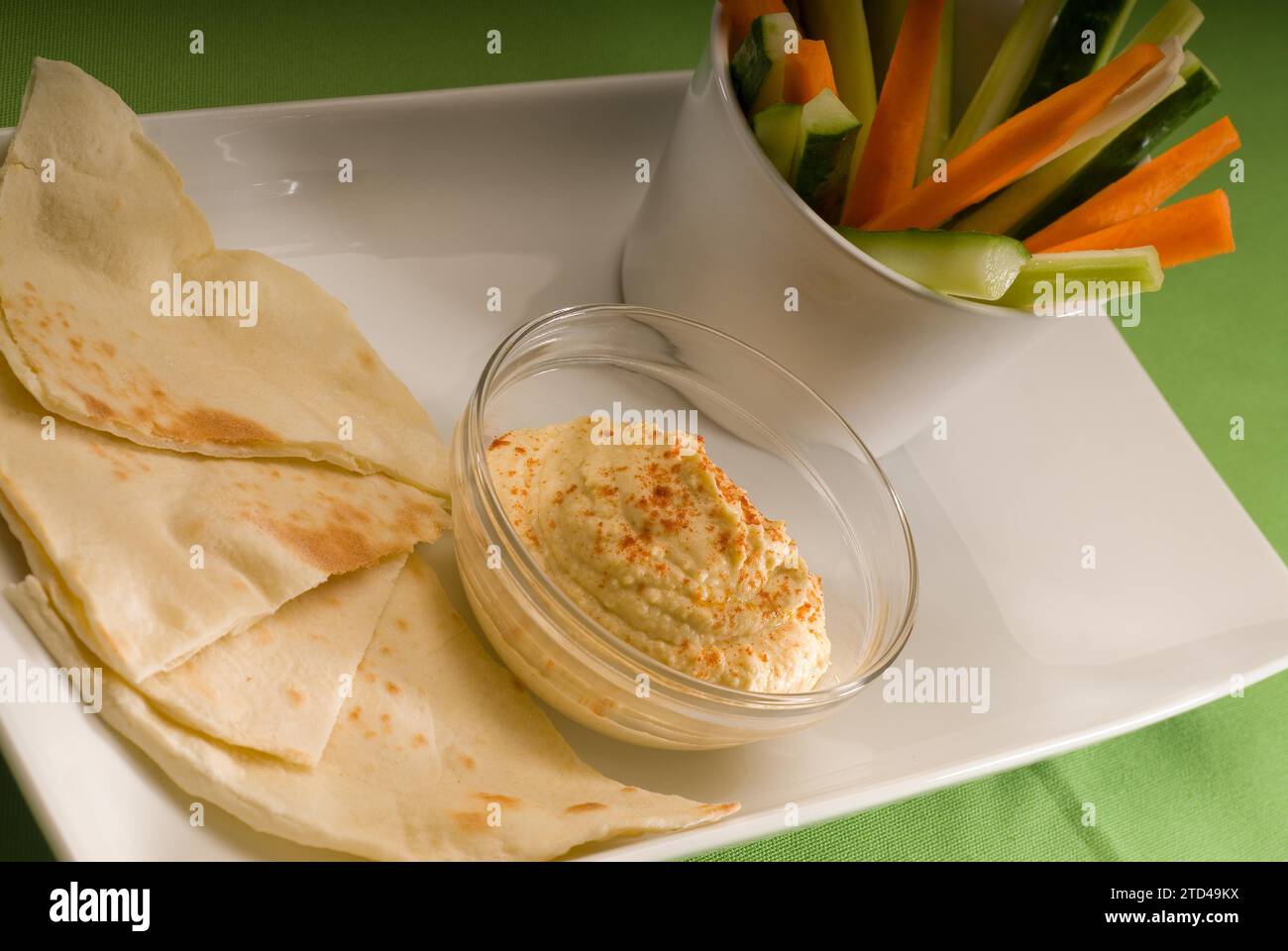 Middle eastern hummus dip on a glass bowl with homemade pita bread and ...