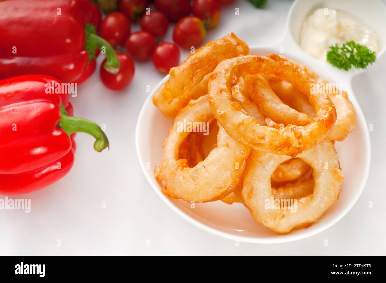 Golden deep fried onion rings served with mayonnaise dip and fresh ...