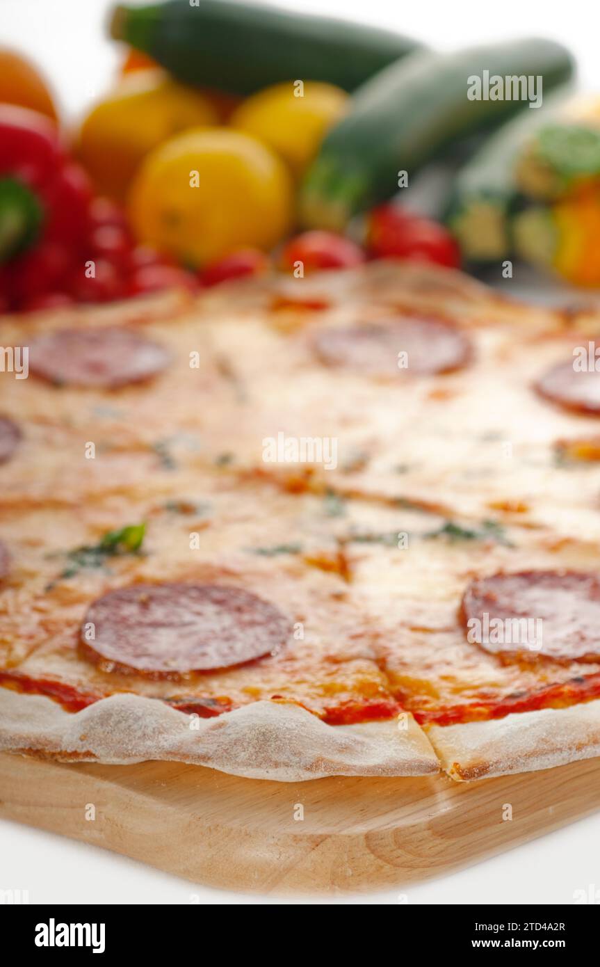 Italian original thin crust pepperoni pizza with fresh vegetables on ...