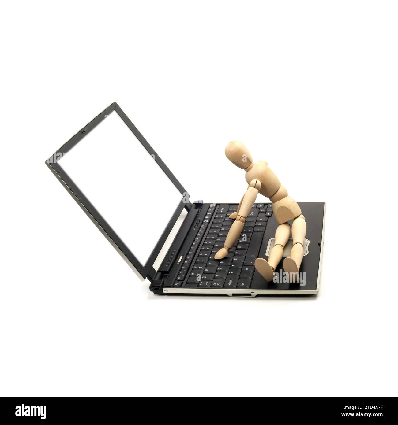 Wood mannequin sitting on a laptop isolated on white background Stock ...