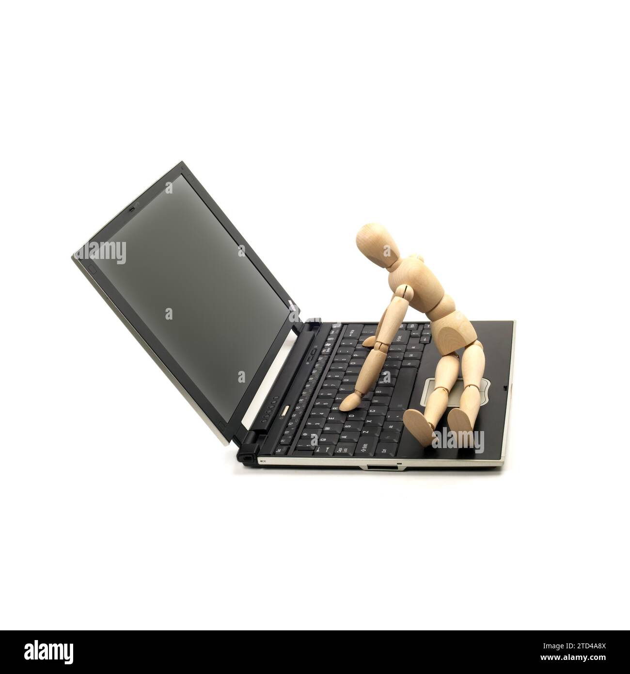 Wood mannequin sitting on a laptop isolated on white background Stock ...