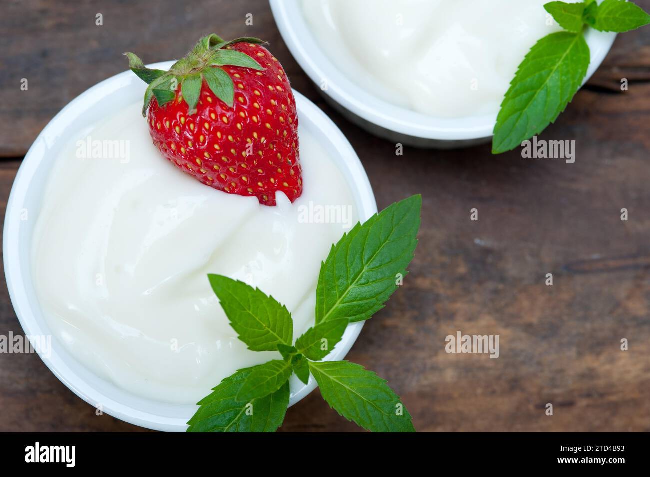 Organic Greek yogurt and strawberry on a rustic wood table Stock Photo ...