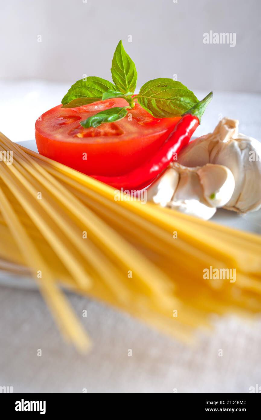 Italian spaghetti pasta tomato raw ingredients basil garlic and red ...