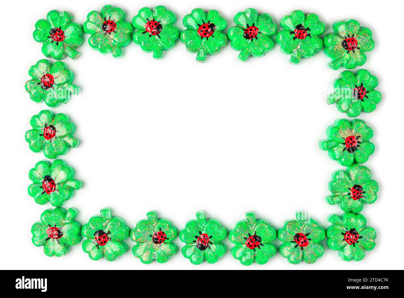 A frame of green shamrocks with ladybirds, lucky charm, on white, copy ...