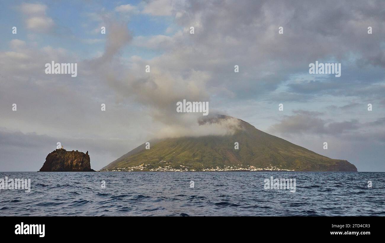 Grey clouds, Strombolichio, small volcanic rock island off Stromboli ...
