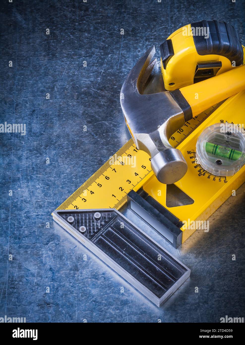 Measuring instruments and claw hammer on a scratched metallic ...