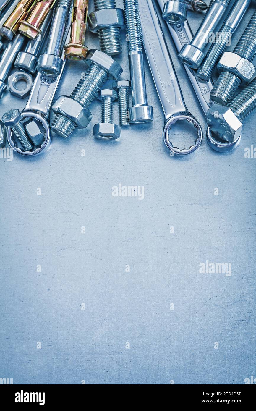 Composition of metal repair tools on metallic background vertical view ...