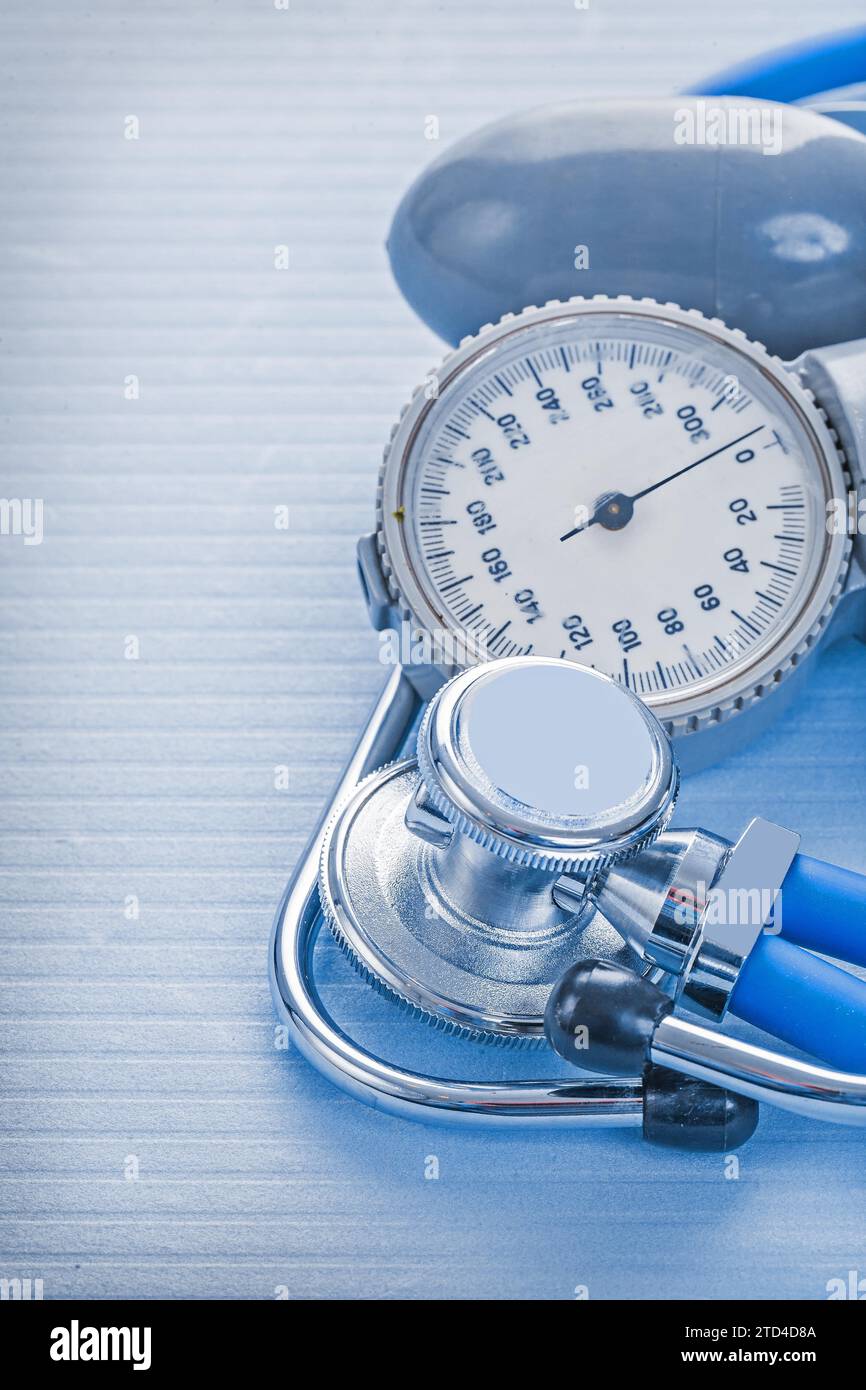 Blood pressure monitor and stethoscope on a blue background Stock Photo ...