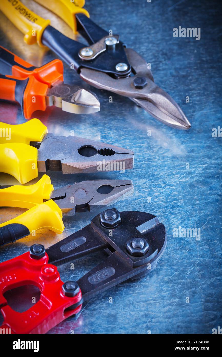 Bolt cutters tin snips pliers pliers on scratched vintage metallic ...