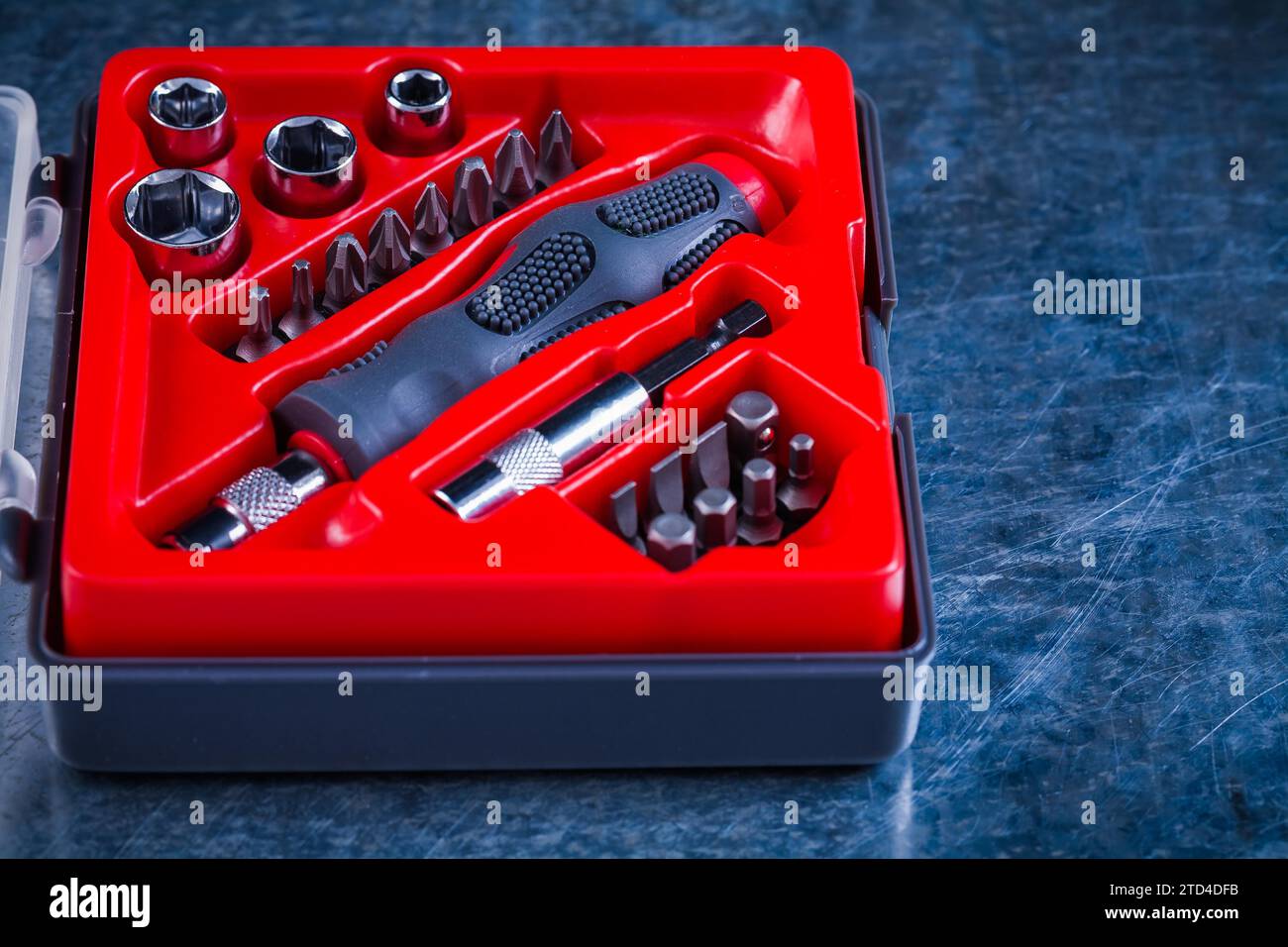 Opened toolbox with screwdriver and interchangeable bits and heads on a ...