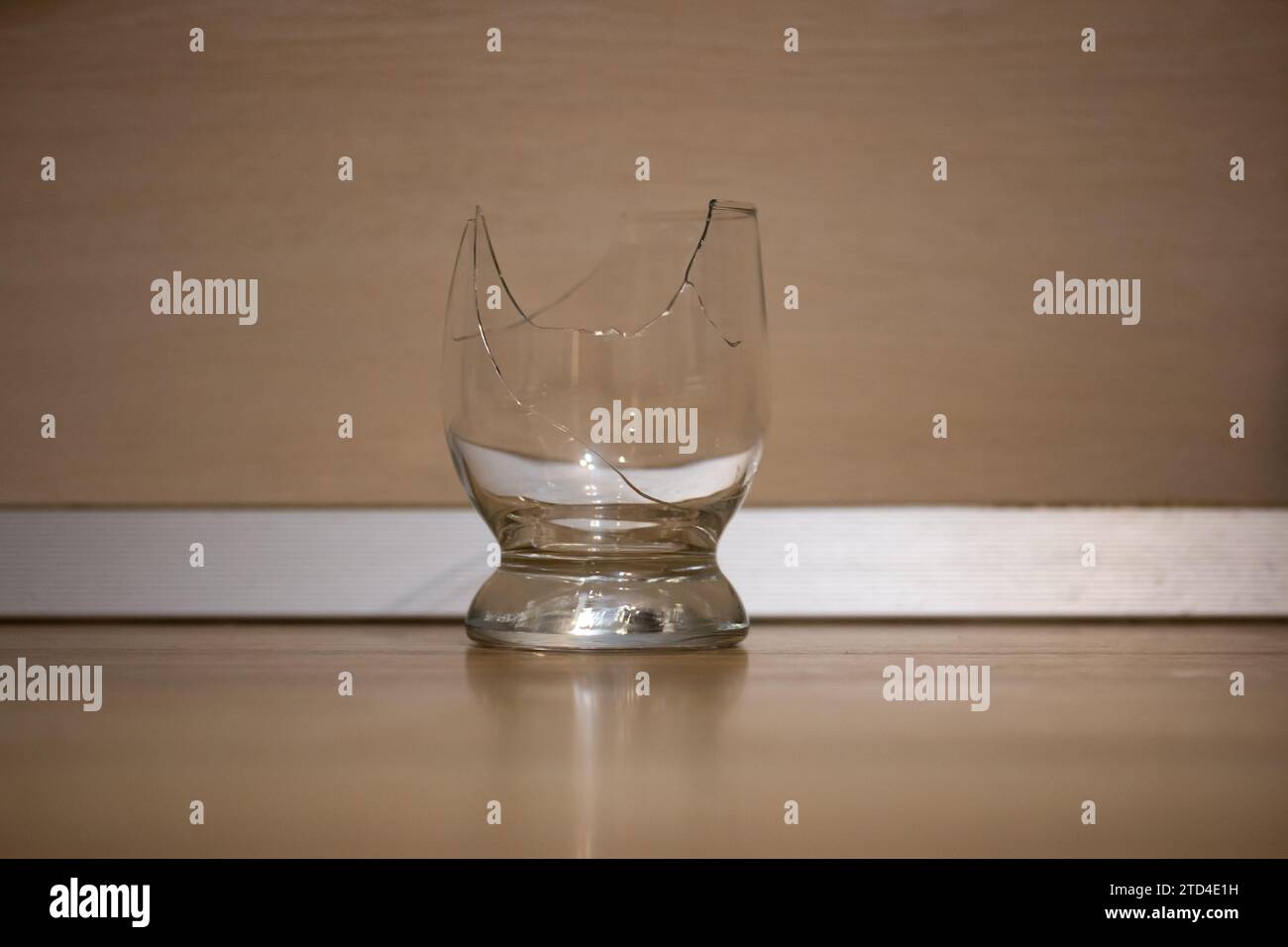 Broken transparent drinking glass in the kitchen. Sharp dangerous ...