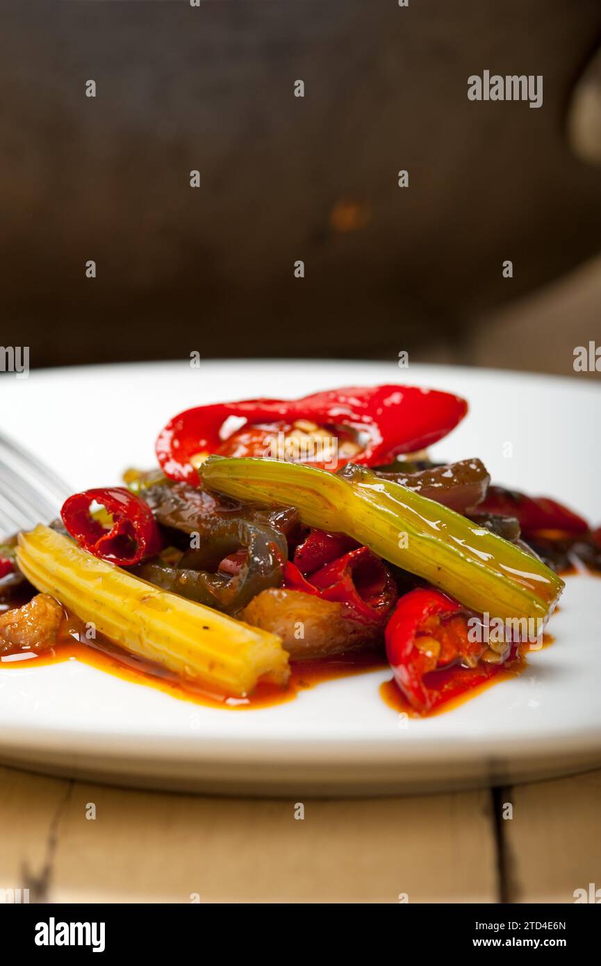 Fried chili pepper and vegetable on a iron wok pan Stock Photo - Alamy