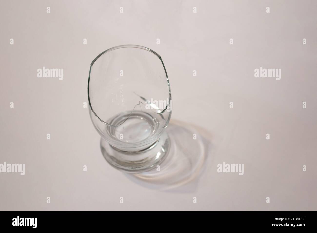 Broken transparent drinking glass in the kitchen. Sharp dangerous ...