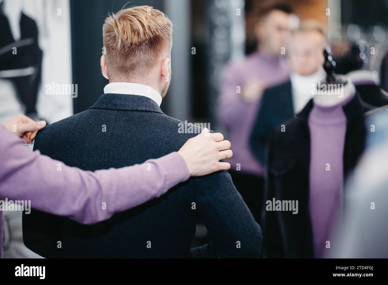 Business successful man businessman chooses a suit in a clothing store ...