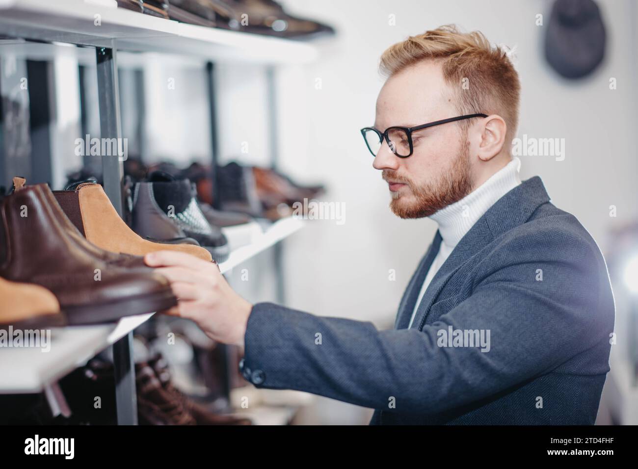Business successful man businessman chooses shoes for himself in a shoe ...