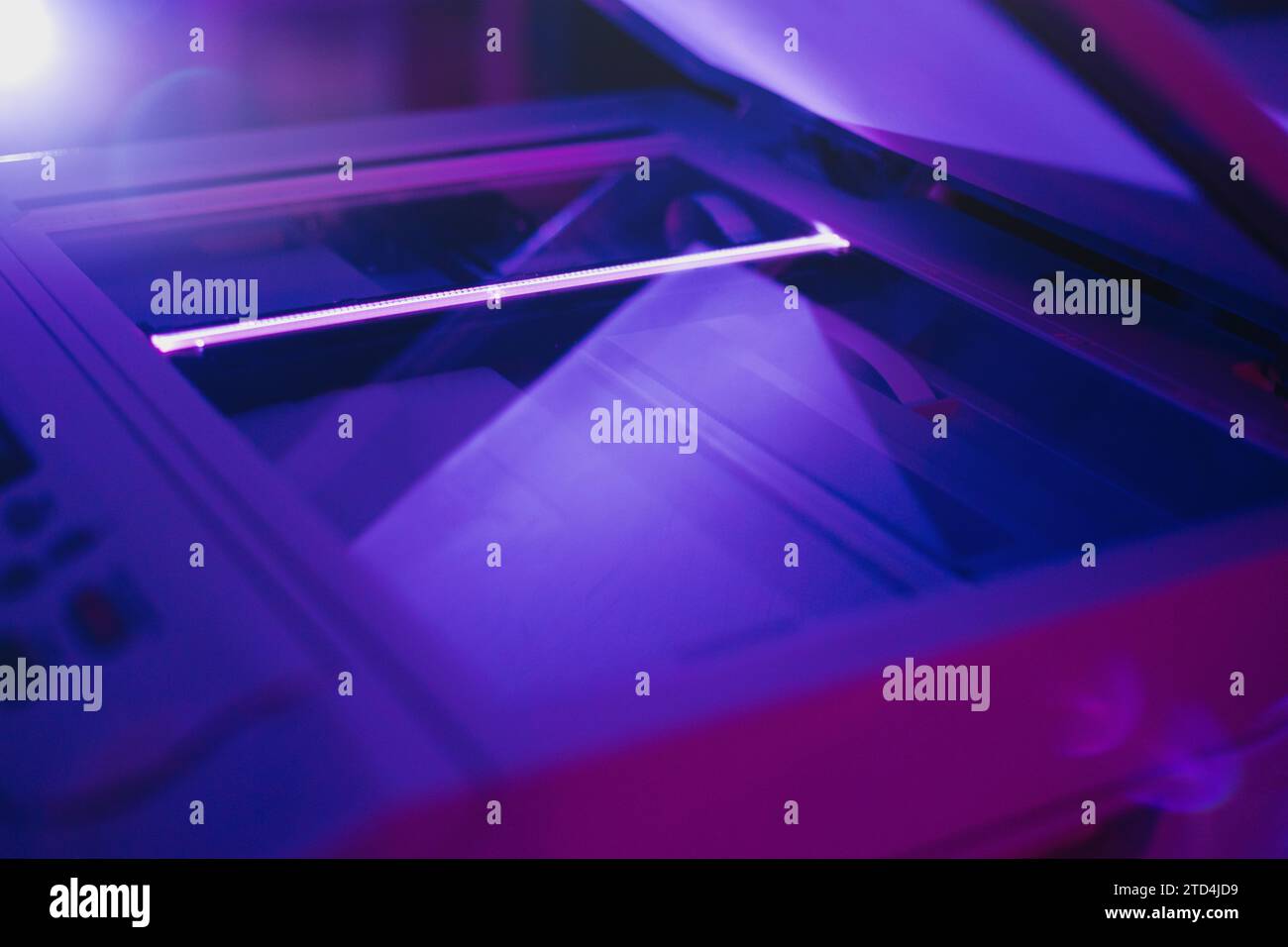 Copier scanner with a bright light inside. Office hazards concept ...