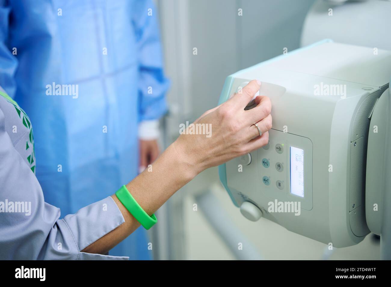 Experienced radiographer preparing person for radiographic examination ...