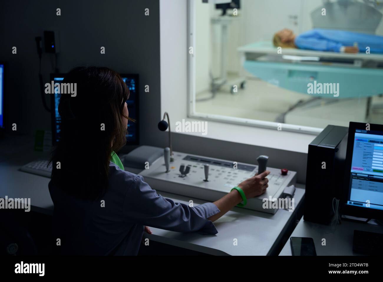 Experienced radiographer conducting radiographic examination of adult ...