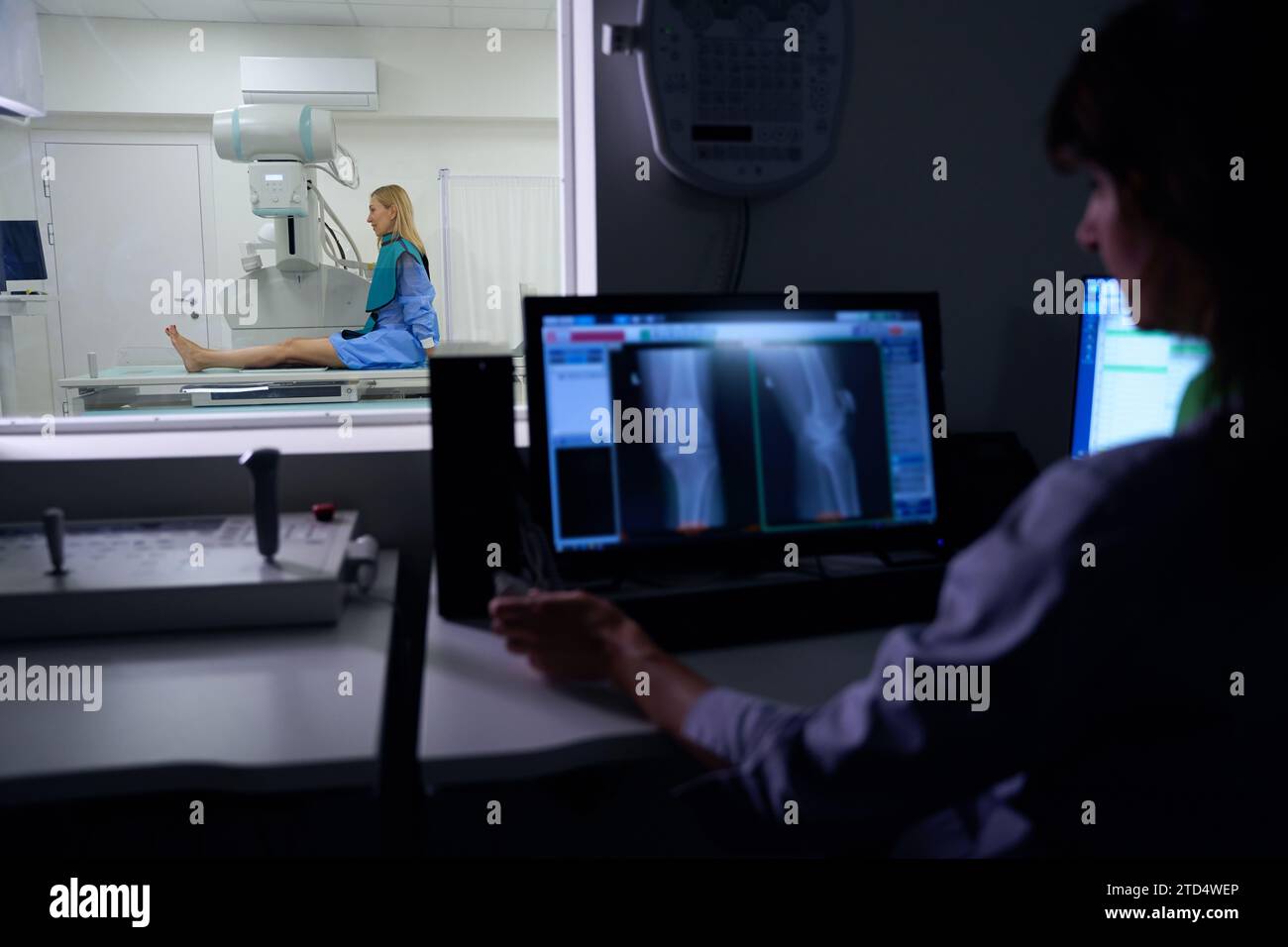 Experienced radiographer is performing digital lower limb radiography ...