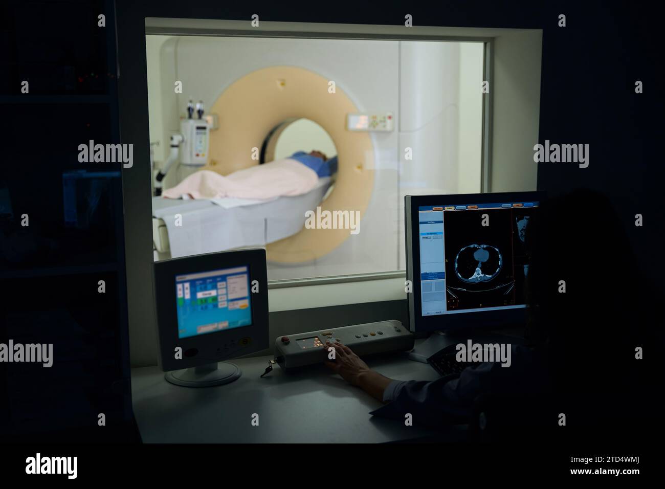Radiographer performing diagnostic computed tomography on female patient Stock Photo - Alamy