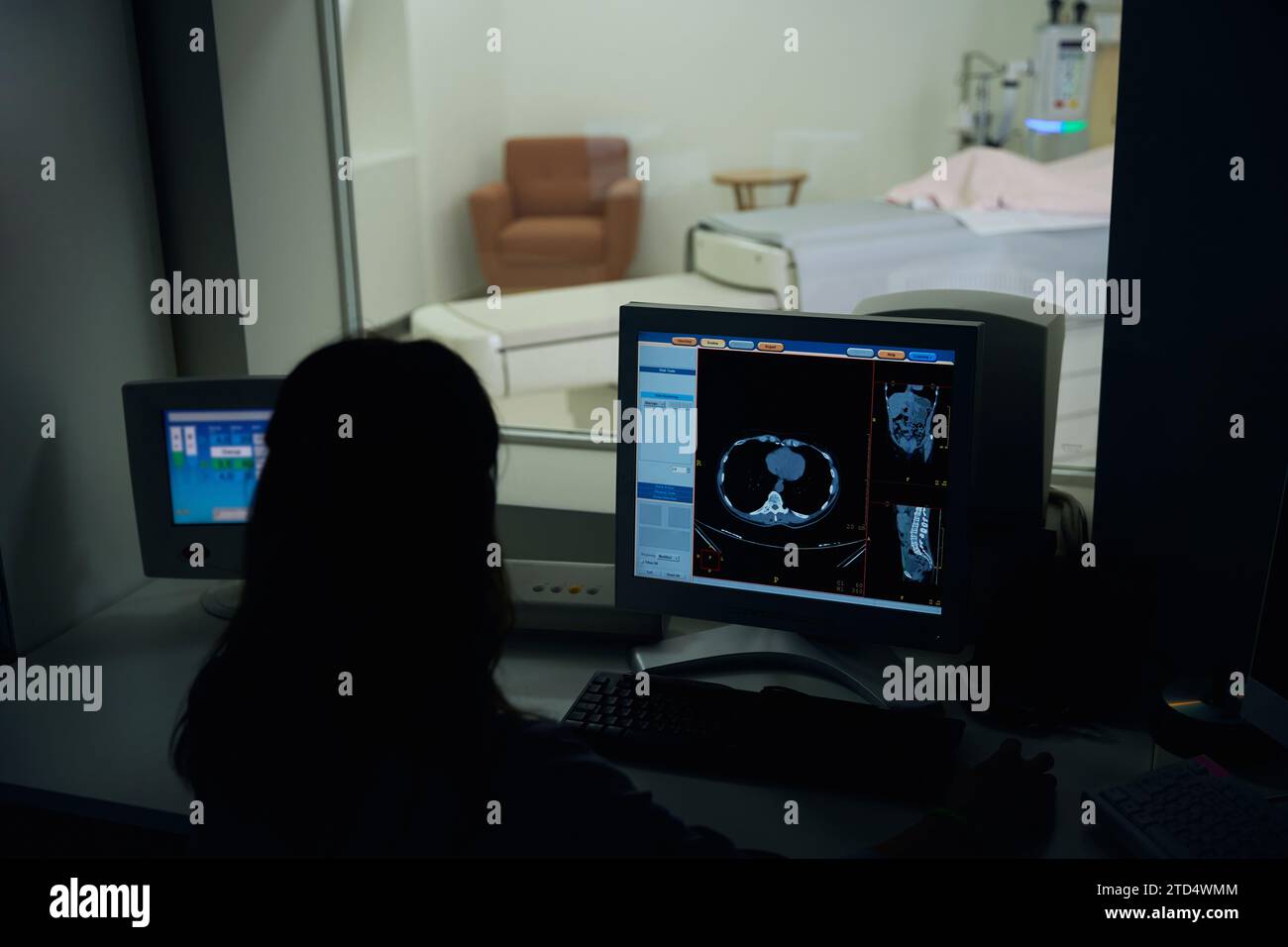 Radiologic technologist conducting computed tomography scanning in ...