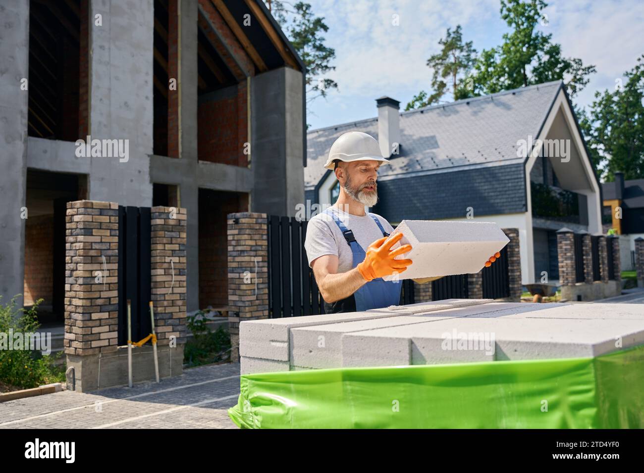 Construction worker examining concrete hi-res stock photography and ...